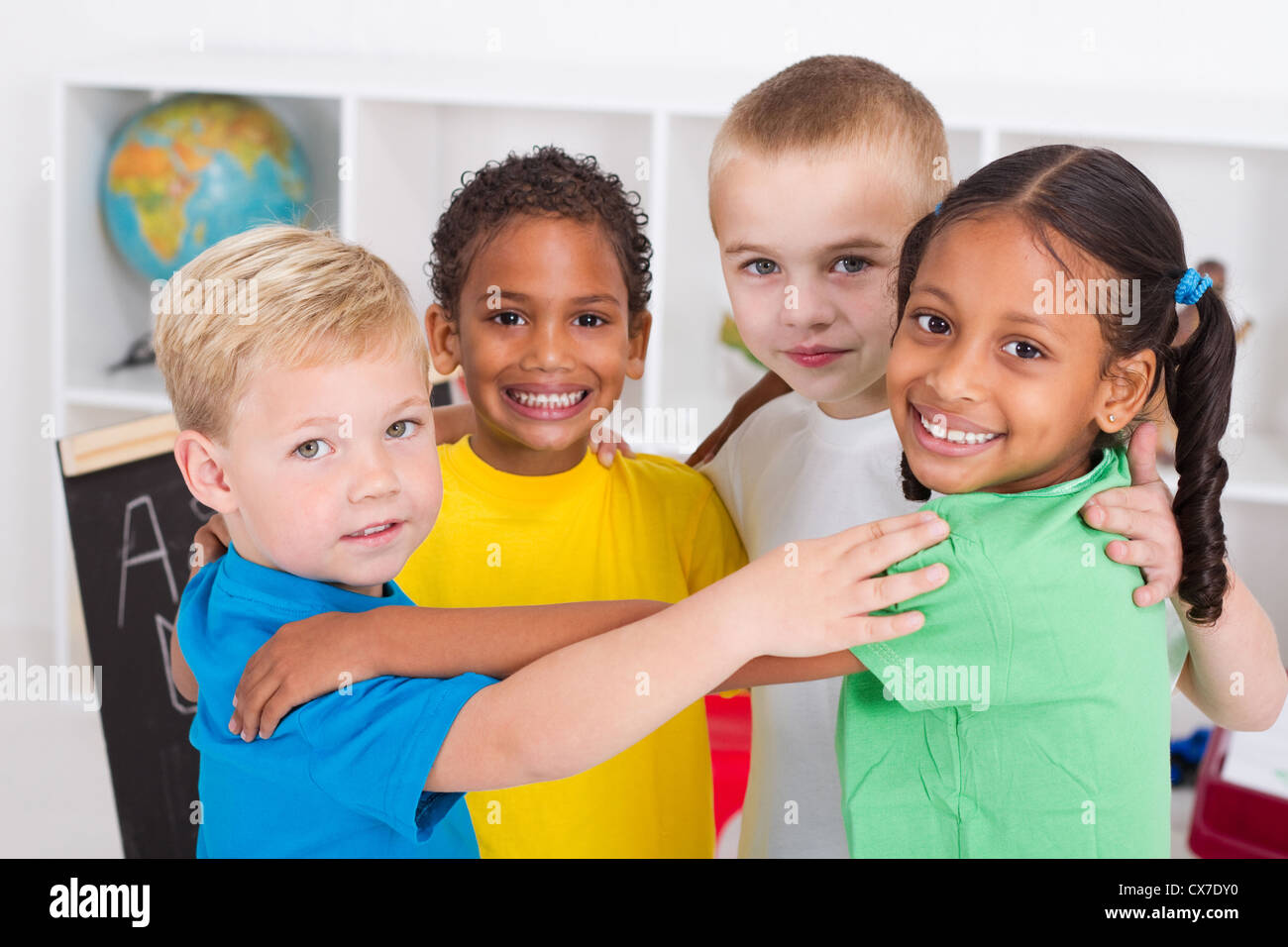 group of happy preschool kids hugging Stock Photo - Alamy