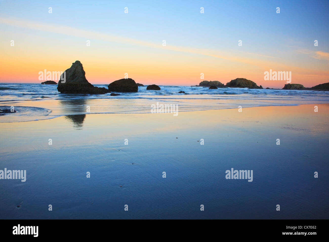 Rock Formations Reflecting In Tide Pools At Low Tide On Bandon Beach At ...