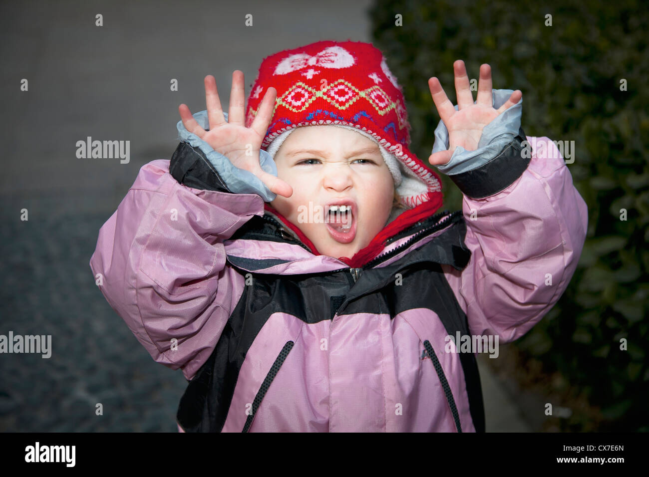 A Young Girl Making A Roaring Face And Gesture; Beijing, Chine Stock ...