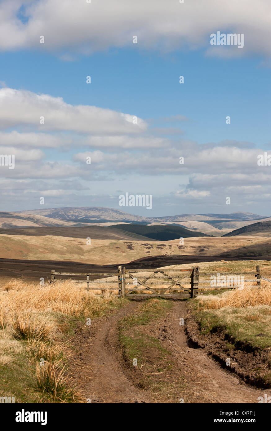 A Wooden Gate Across A Dirt Trail With A Rolling Hill Landscape In The ...