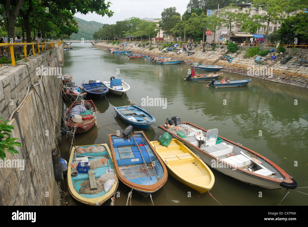 Small fishing boats moored on the Silvermine river canal. Mui Wo Lantau ...