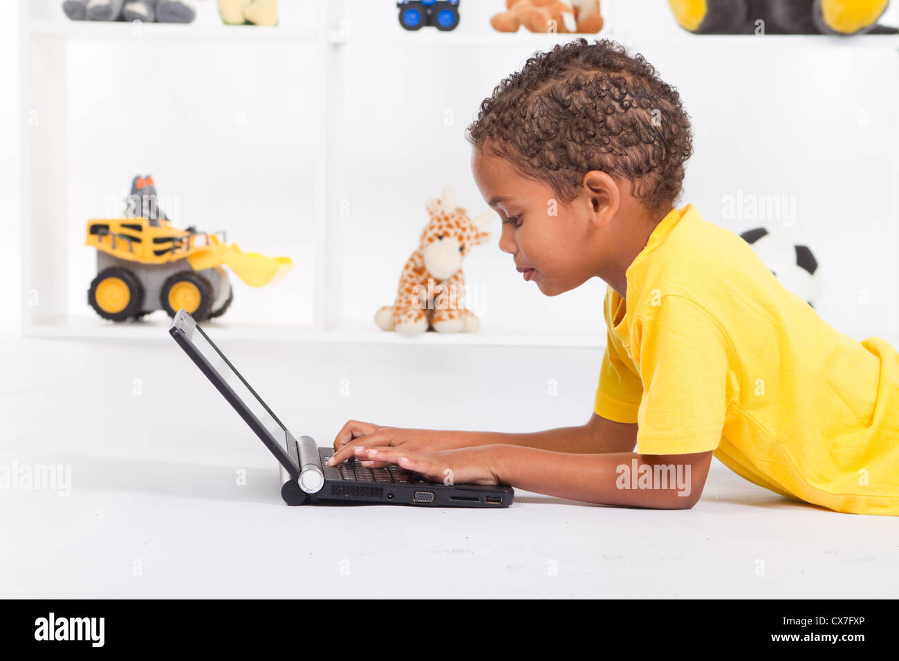 young african american boy playing on laptop computer Stock Photo - Alamy