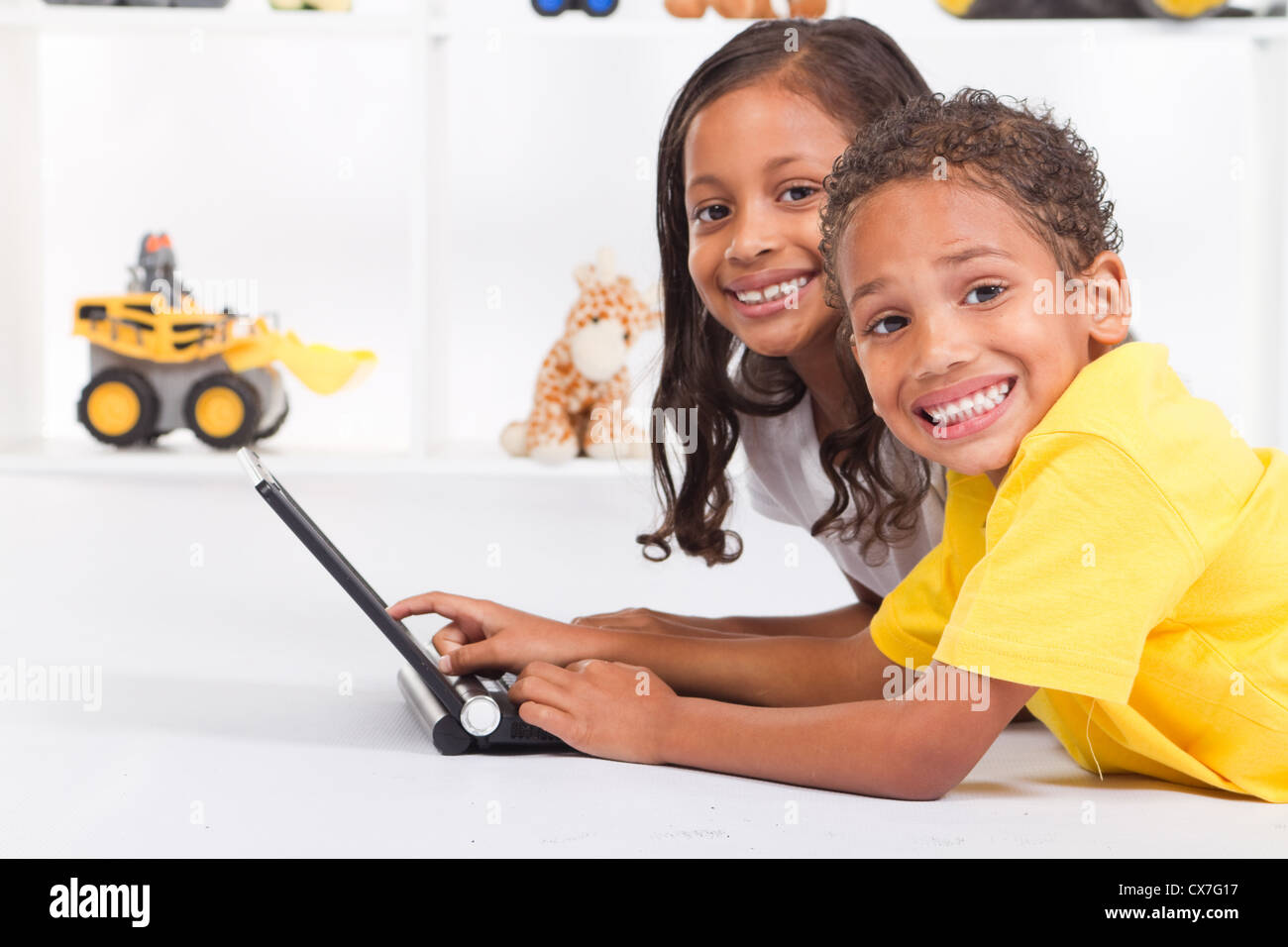 indian brother and sister playing laptop computer Stock Photo - Alamy
