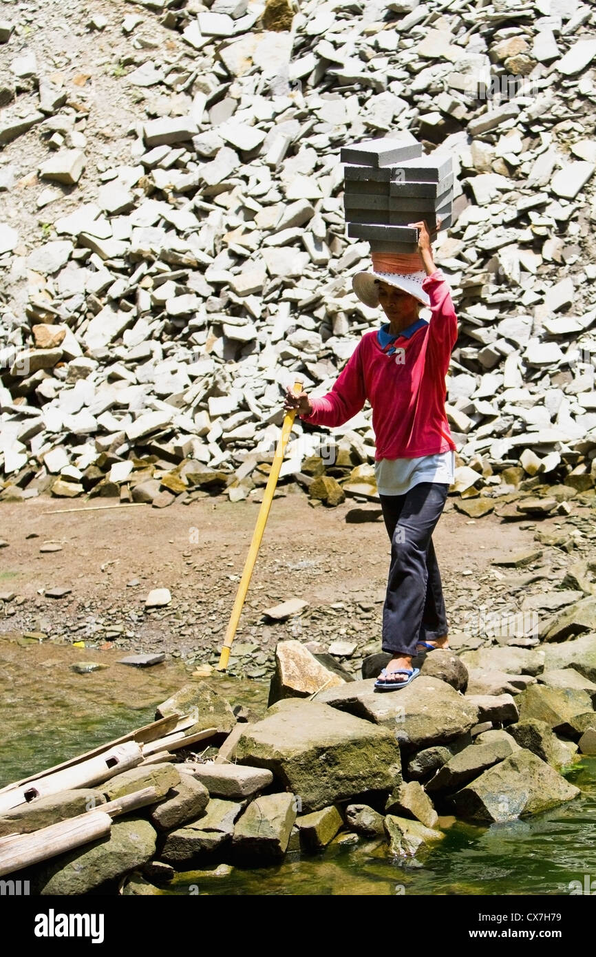 Woman carrying heavy cement blocks hi-res stock photography and images ...
