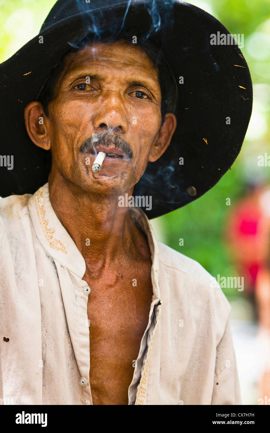 A Seasoned Indonesian Trash Scavenger Poses For A Portrait; Bali ...