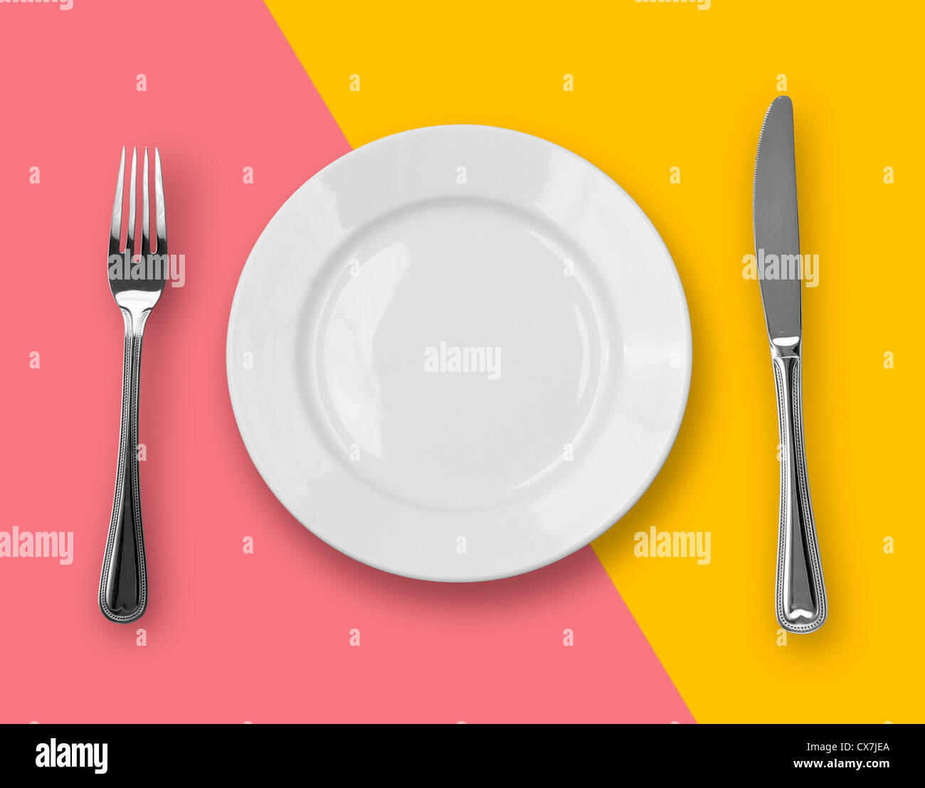 Knife, plate and fork on colorful background Stock Photo - Alamy
