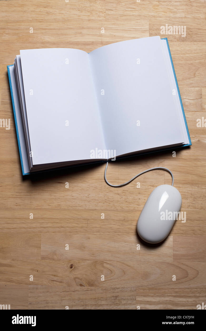 A hardcover book with a computer mouse attached to it Stock Photo - Alamy