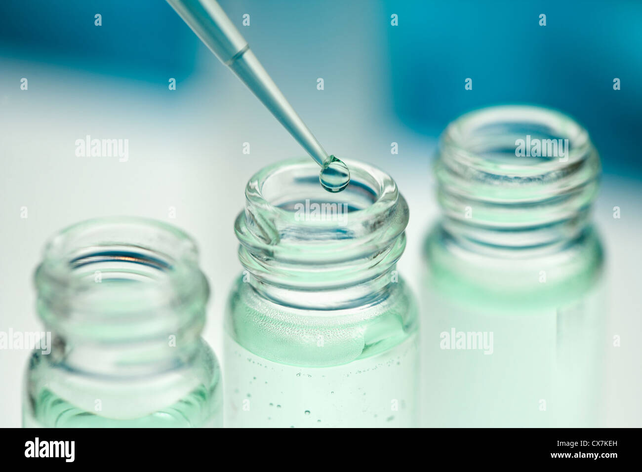 Pipette over 3 glass jars Stock Photo - Alamy