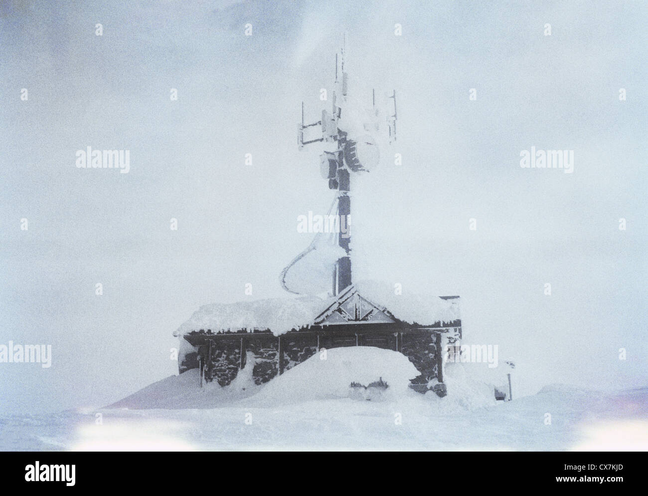 A building with a large antenna covered in snow Stock Photo - Alamy