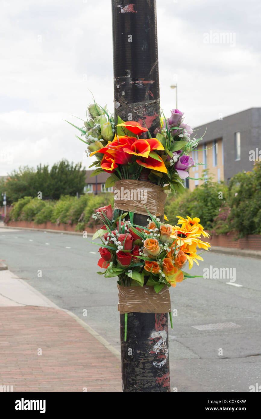 An informal and unofficial roadside death memorial comprising flowers ...