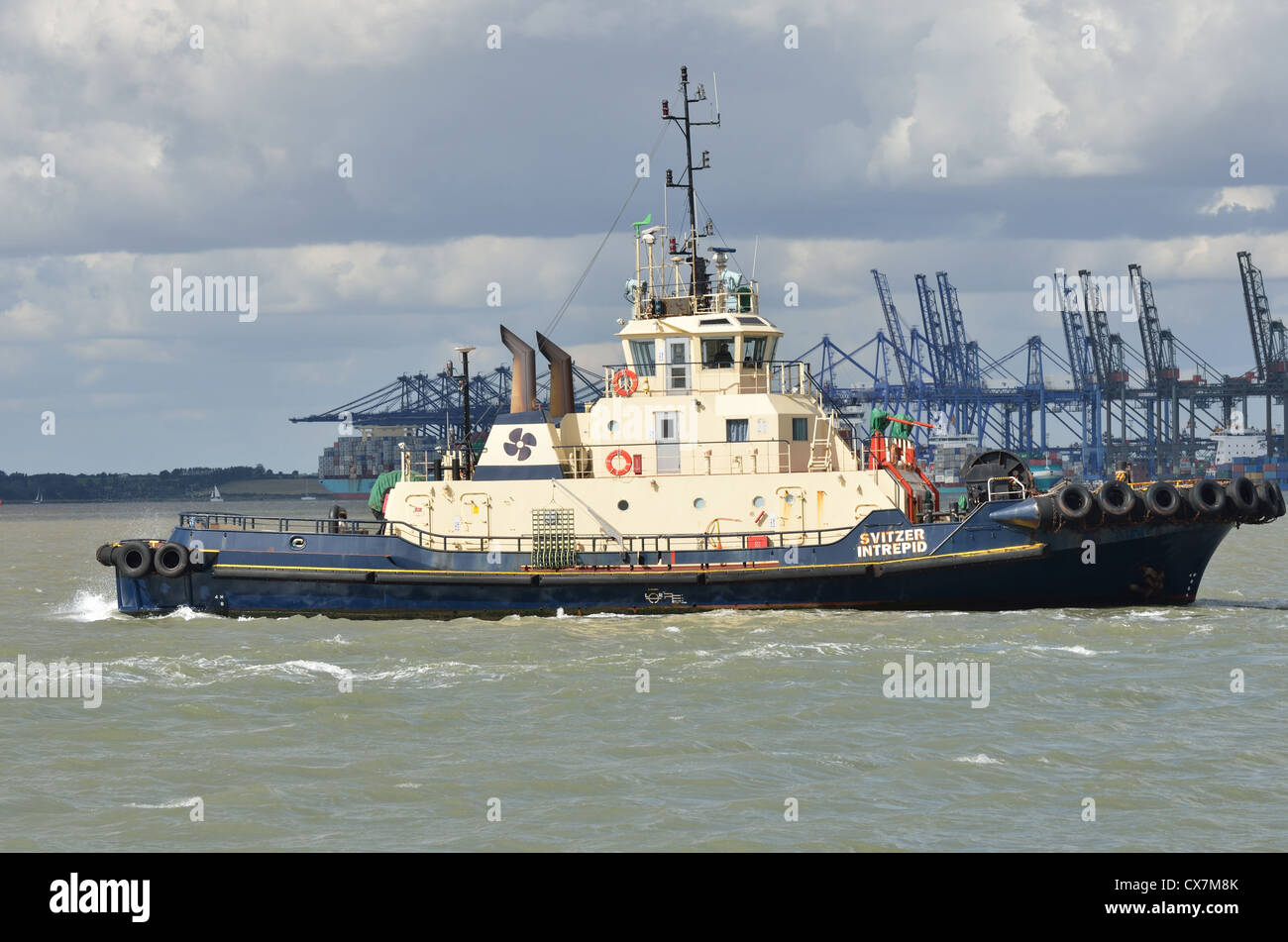 Svitzer intrepid tug boat with felixstowe in background Stock Photo - Alamy