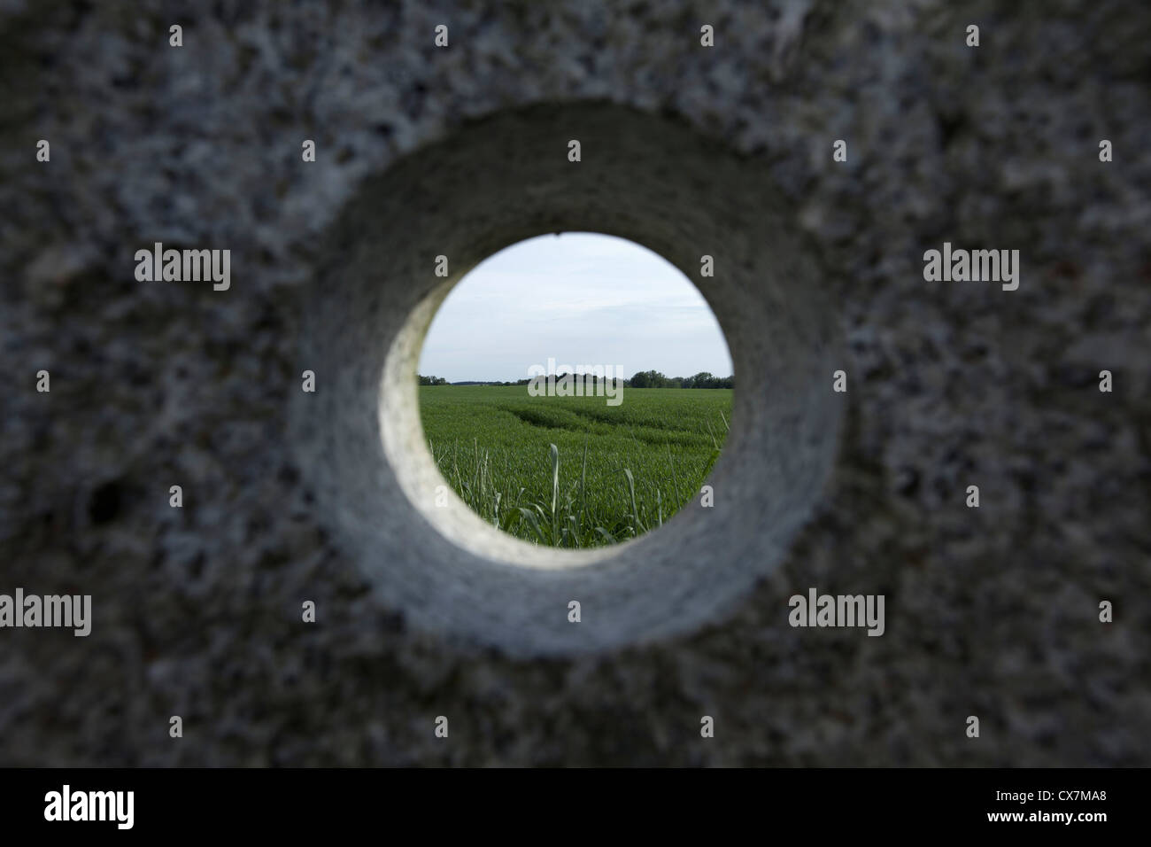 A remote natural landscape seen through a hole in granite Stock Photo ...