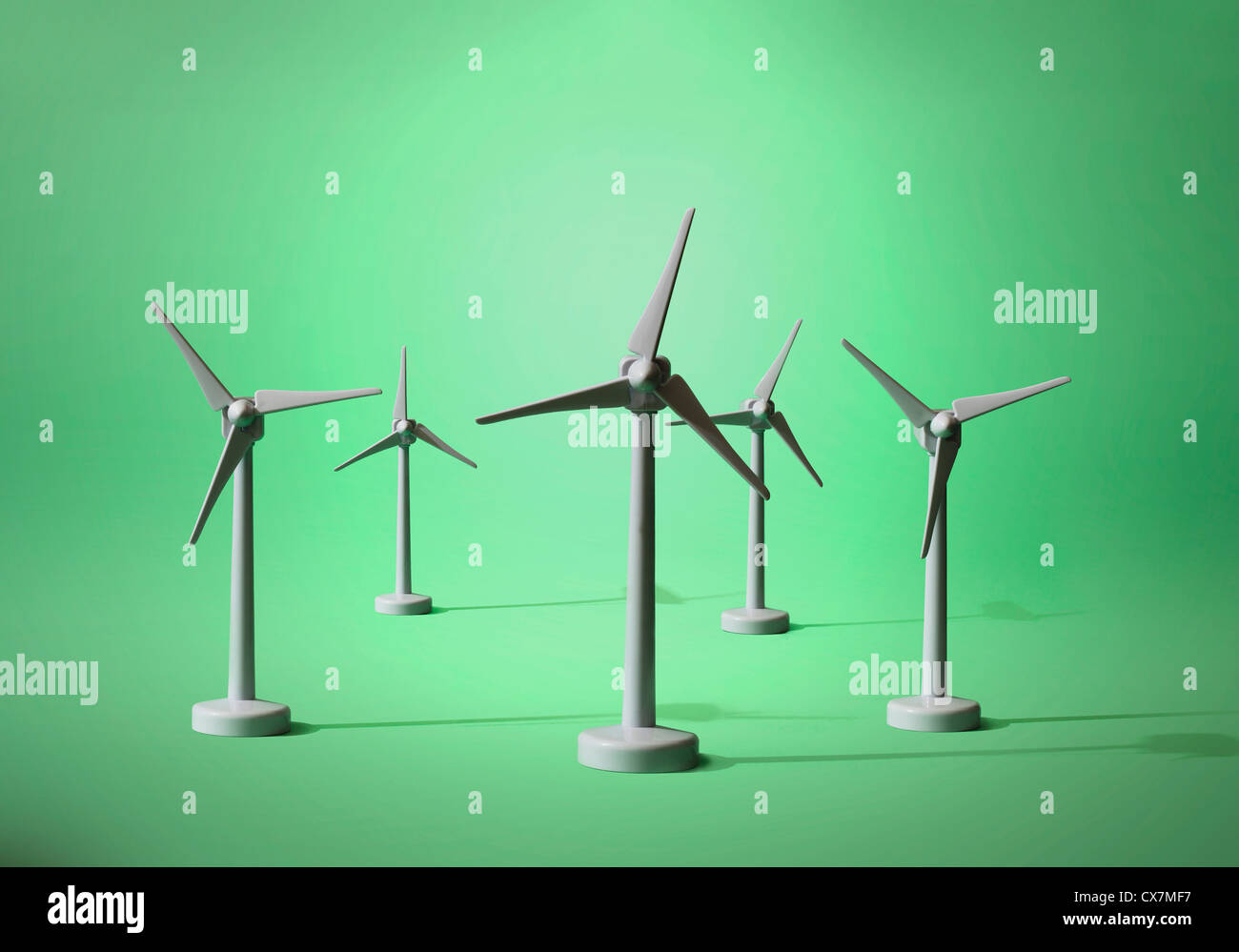 Five models of wind turbines on a green background Stock Photo - Alamy