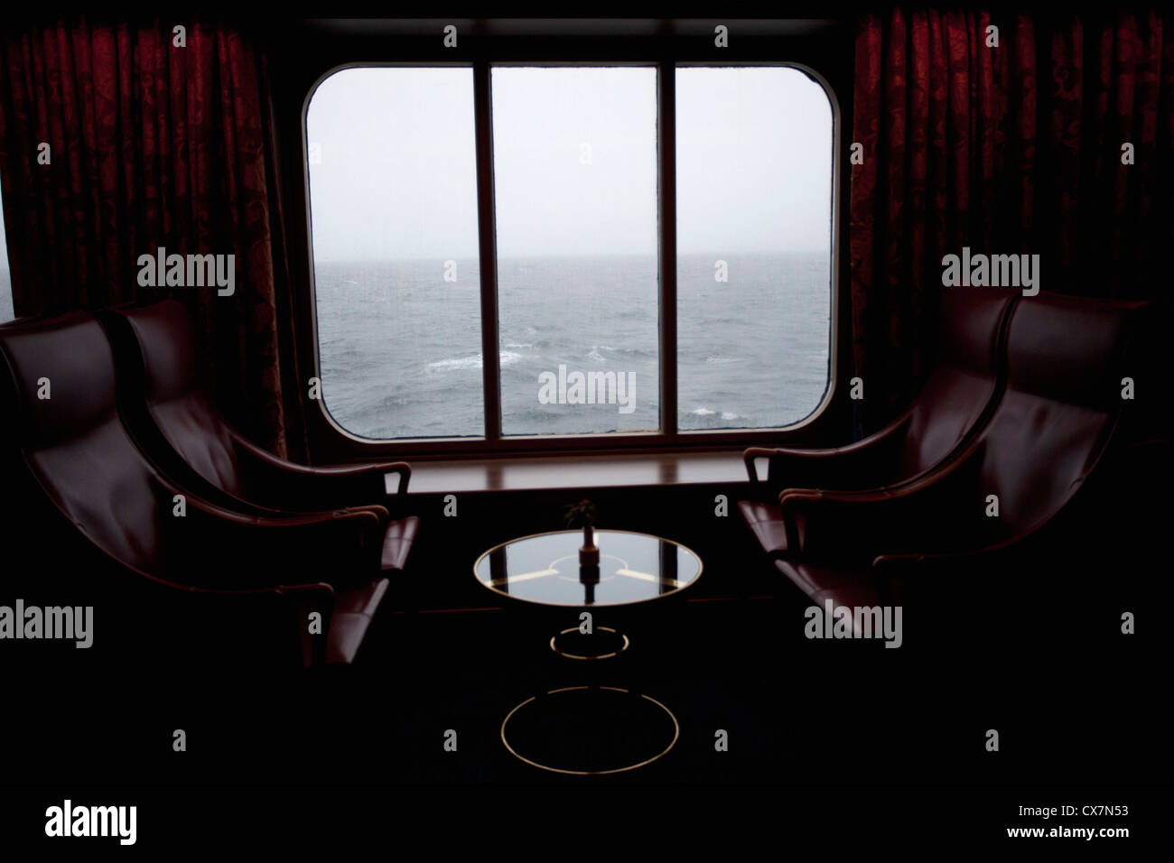 View of Pacific Ocean through the window of lounge area on a passenger ...