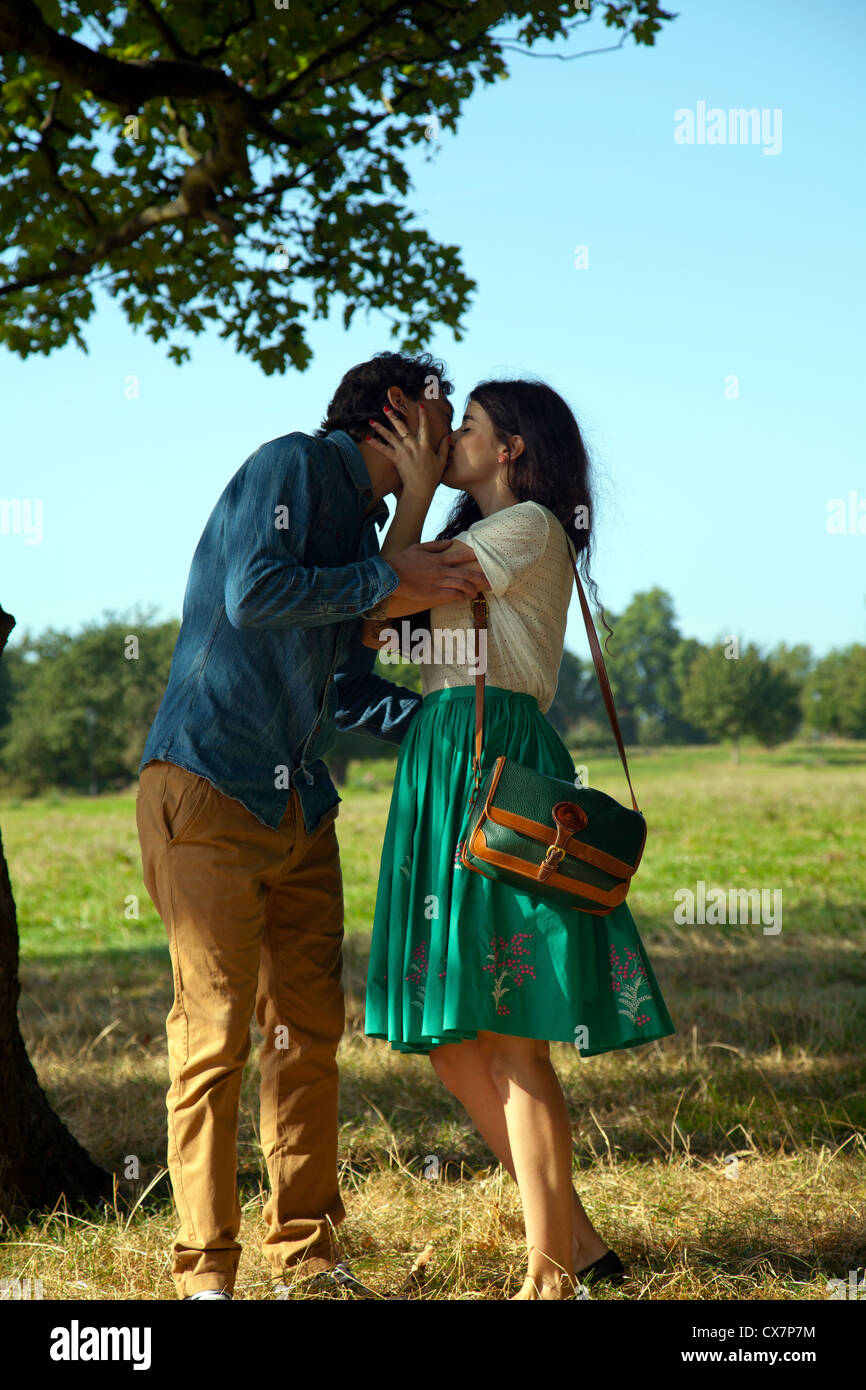 Couple strolling in Park and Kissing Stock Photo - Alamy