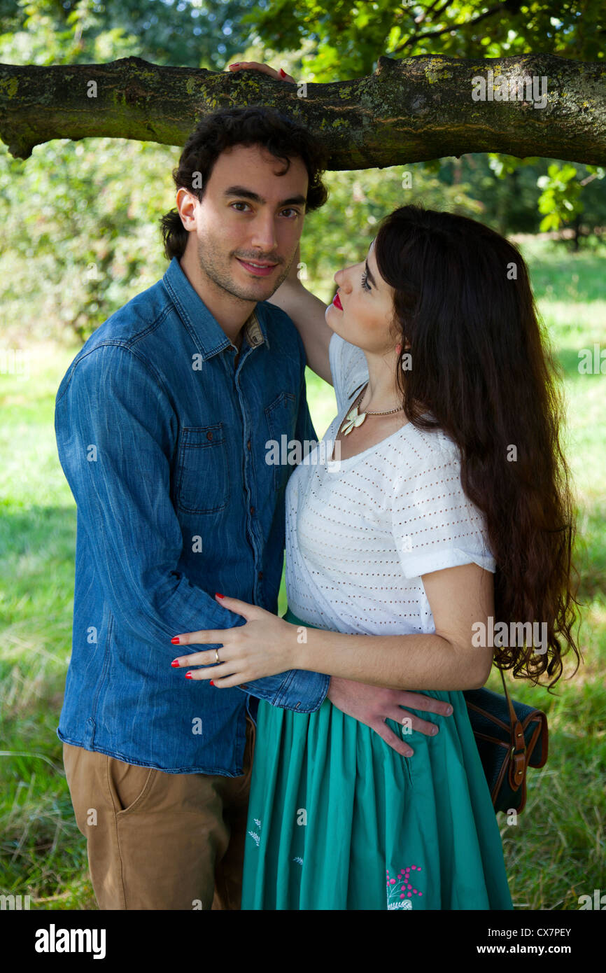 Couple Standing under tree in Park Stock Photo - Alamy