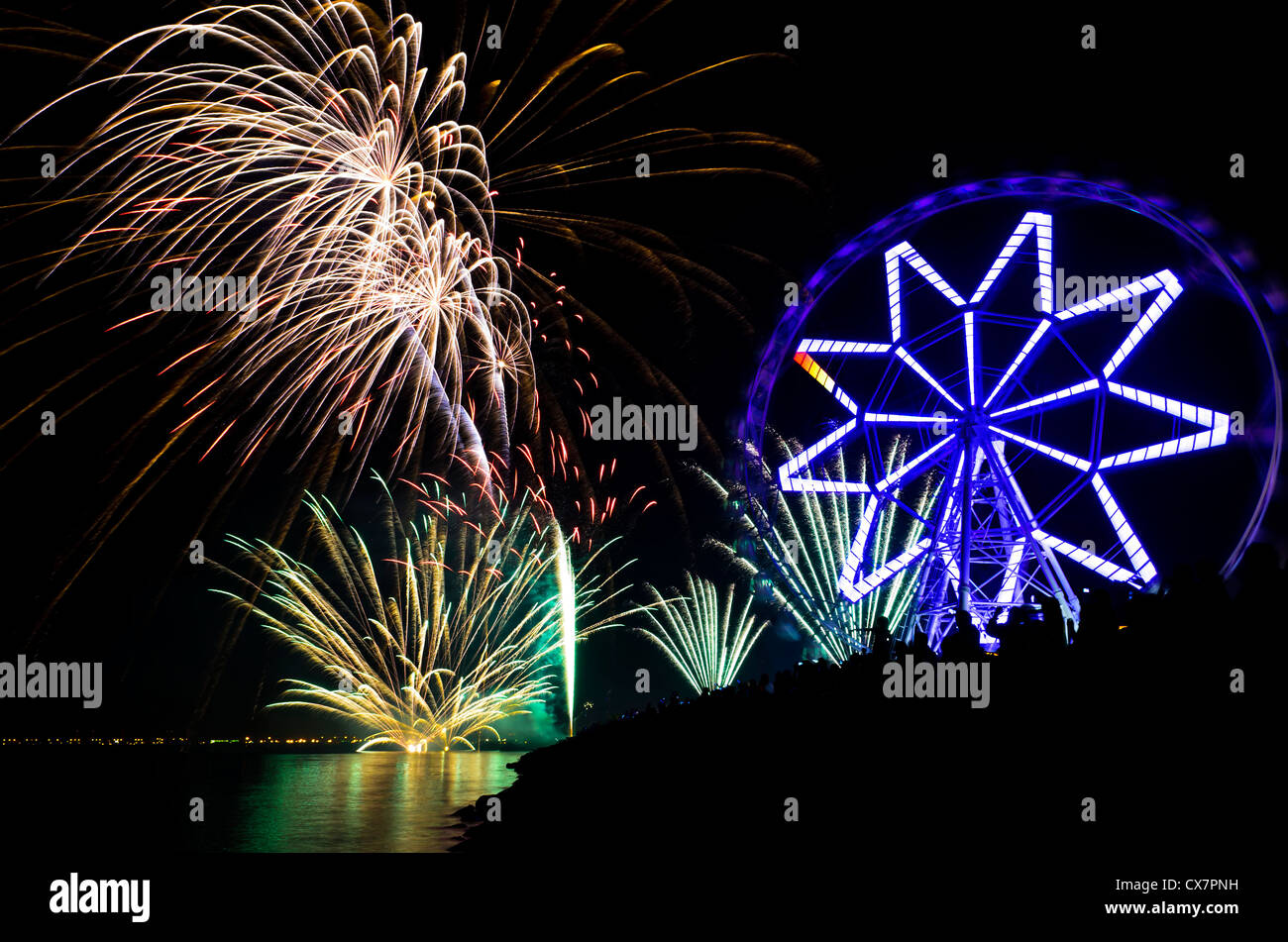 New Year's revelers watch fireworks display by bay, Philippines Stock ...