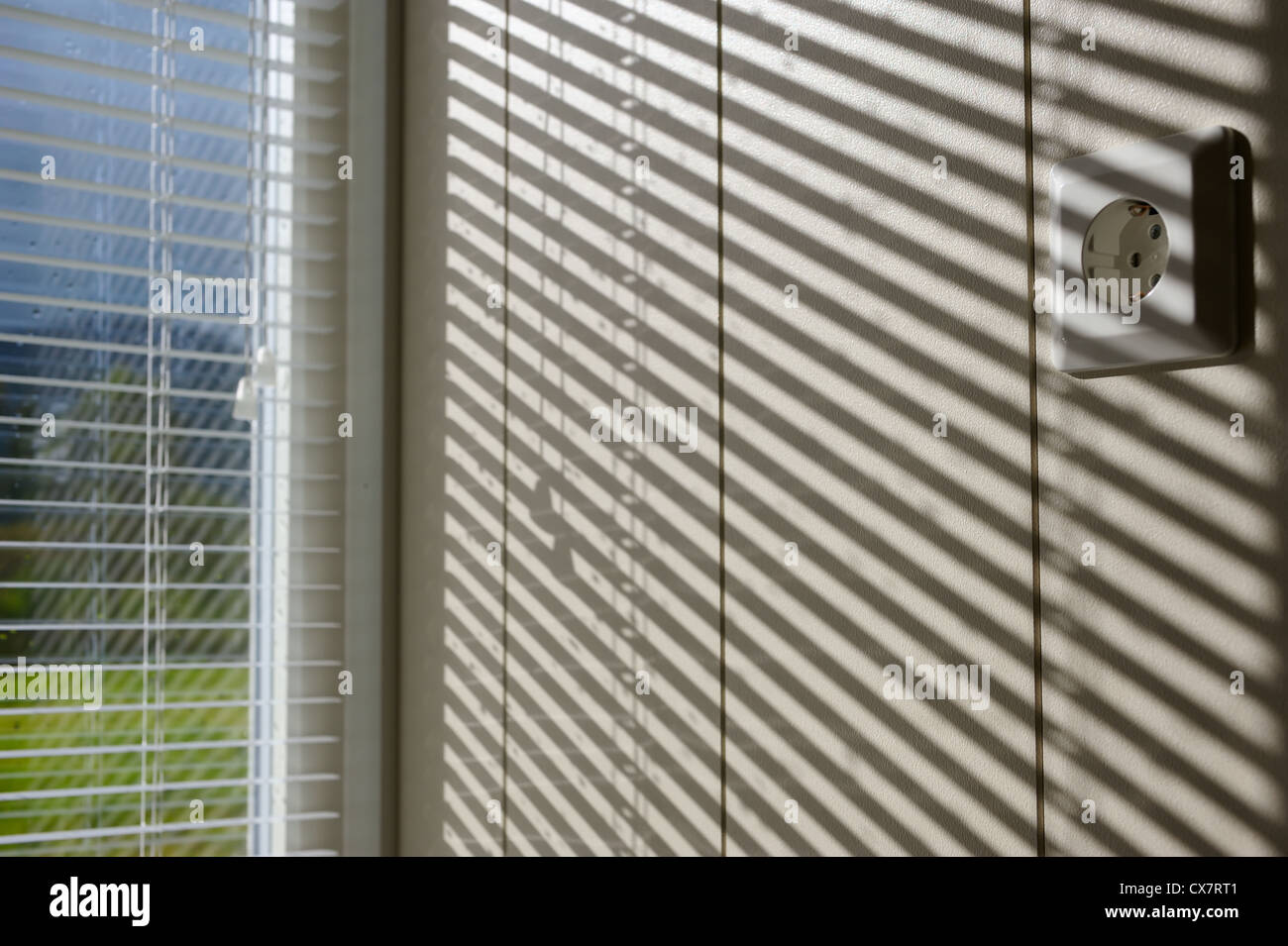 Sunlight after a storm breaks through the blinds Stock Photo - Alamy