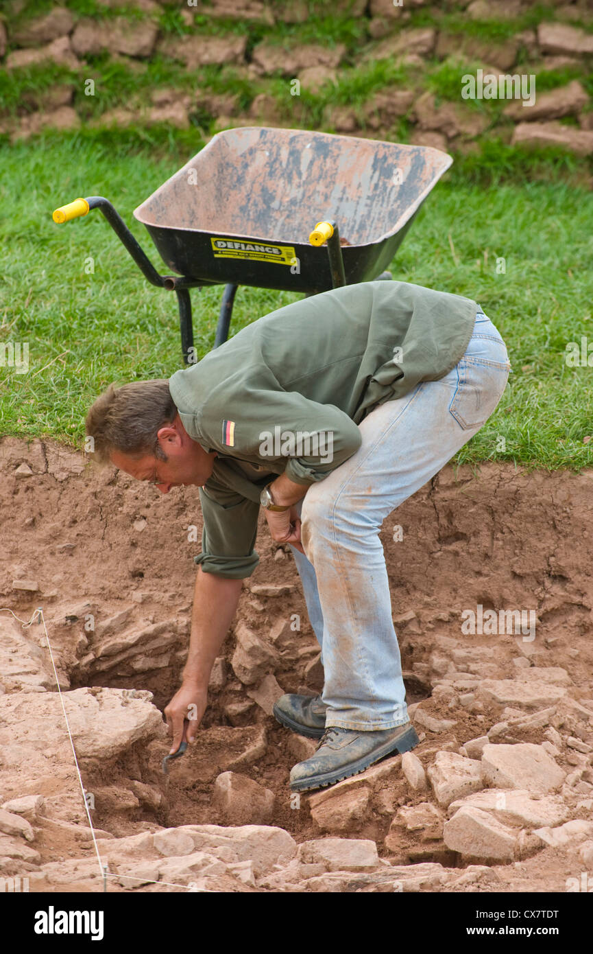 Archaeologist digging a prehistoric neolithic site on Dorstone Hill ...