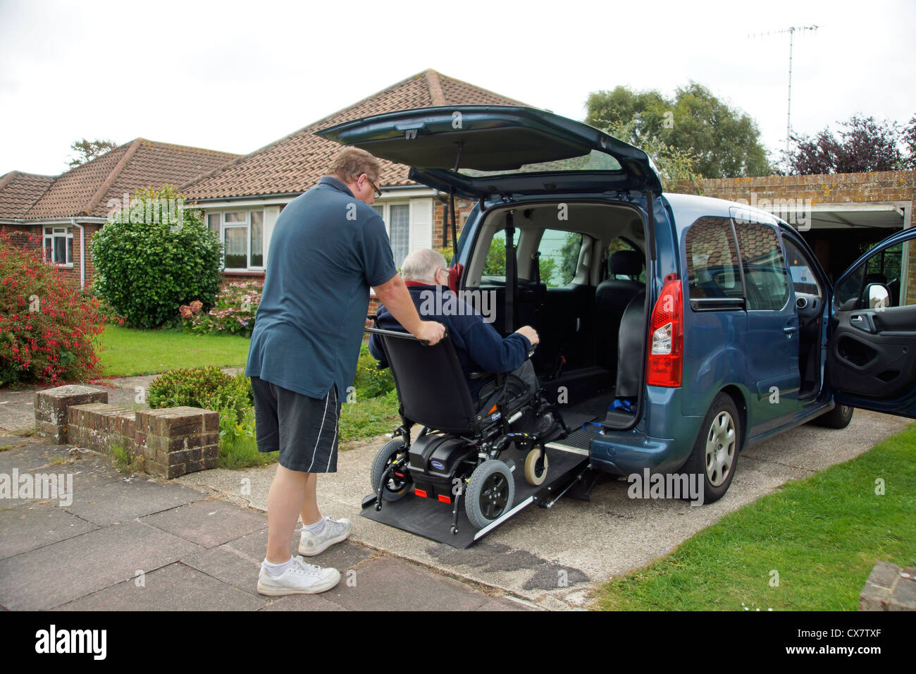 Old Man Pushing Wheelchair Stock Photos & Old Man Pushing Wheelchair ...