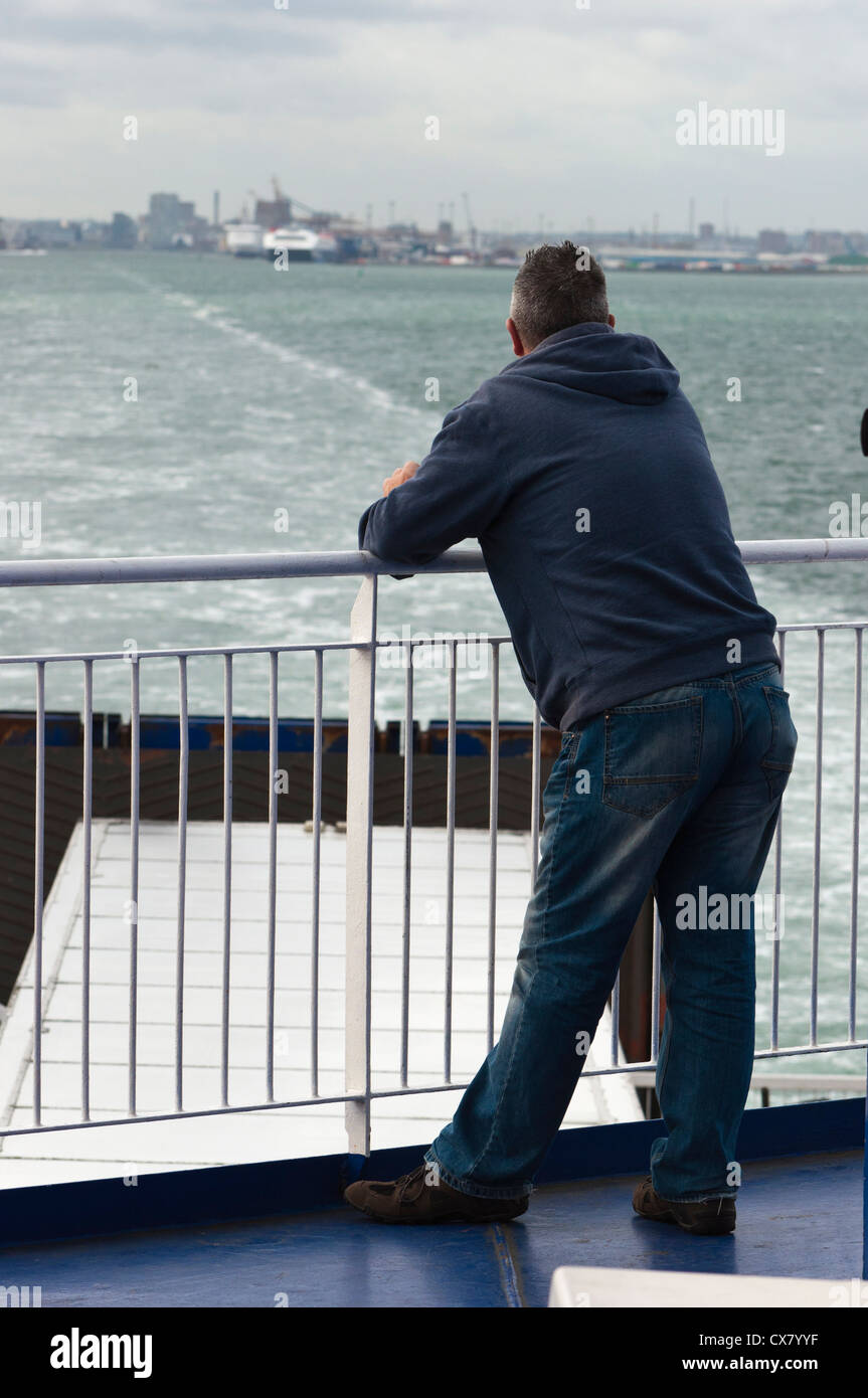Male passenger looking back leaving Belfast on Ferry Stock Photo - Alamy