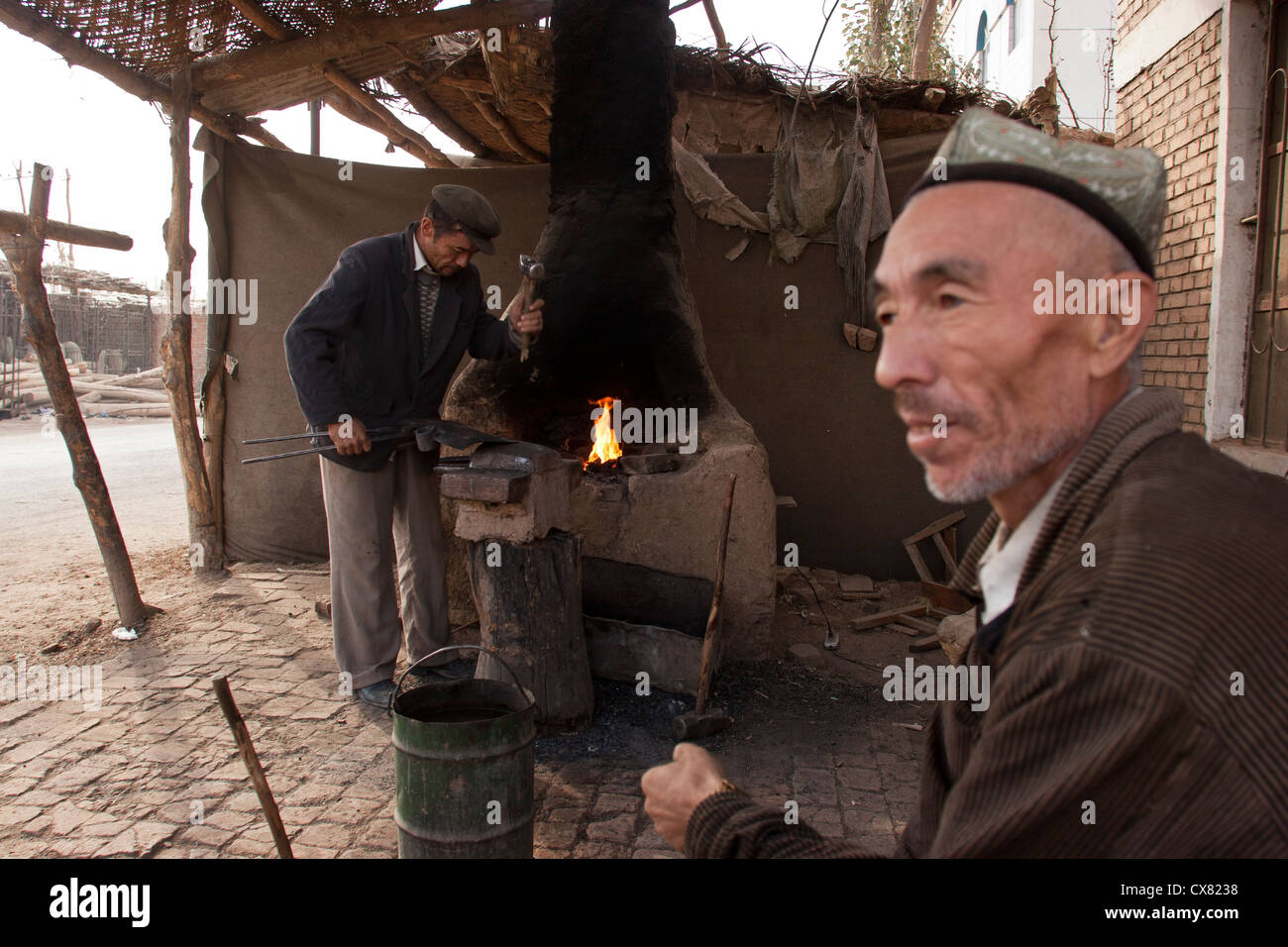 A Uighur blacksmith at work in Turpan, Xinjiang, China Stock Photo - Alamy