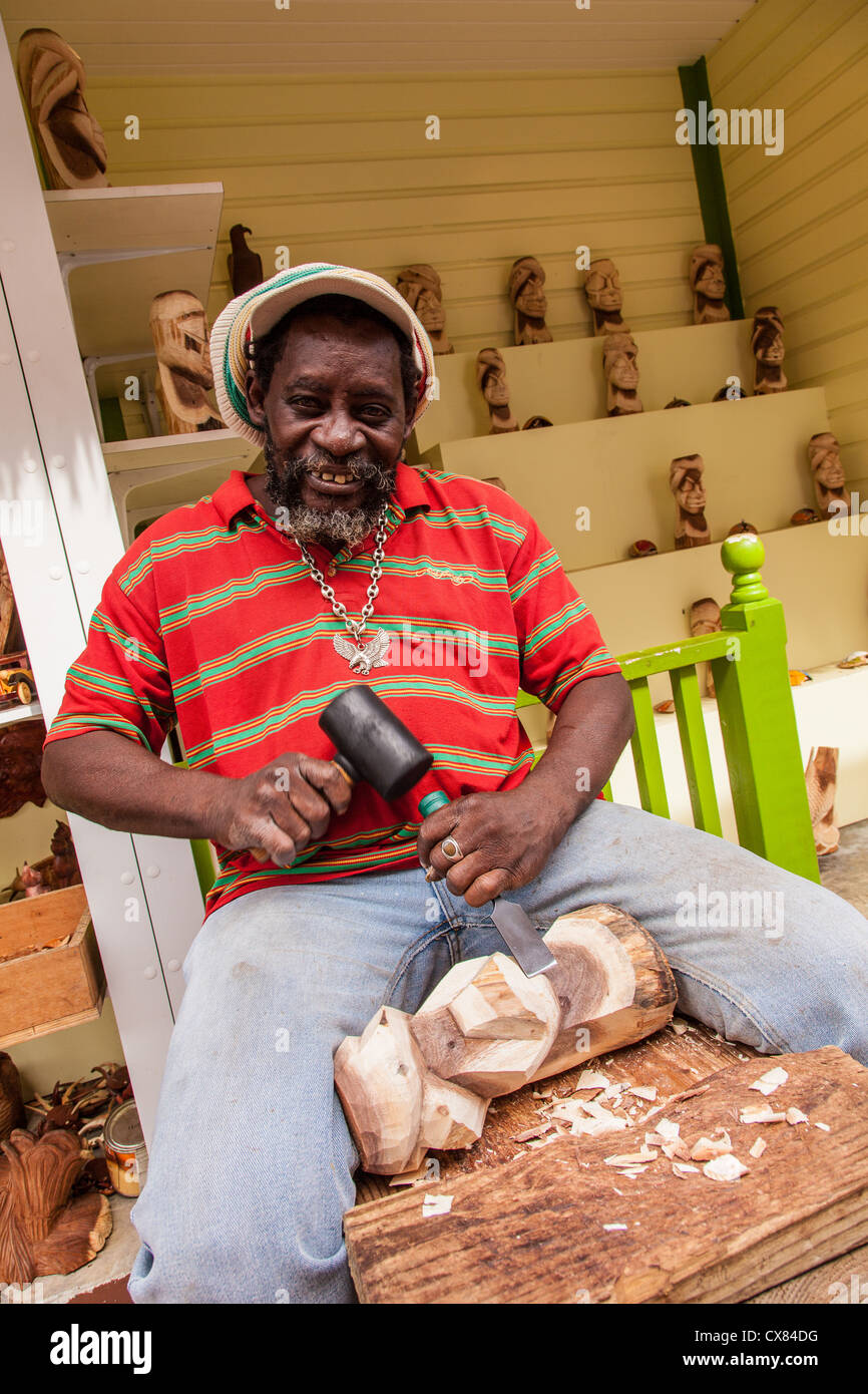 A wood carver works at the Straw Market in Nassau , Bahamas Stock Photo ...