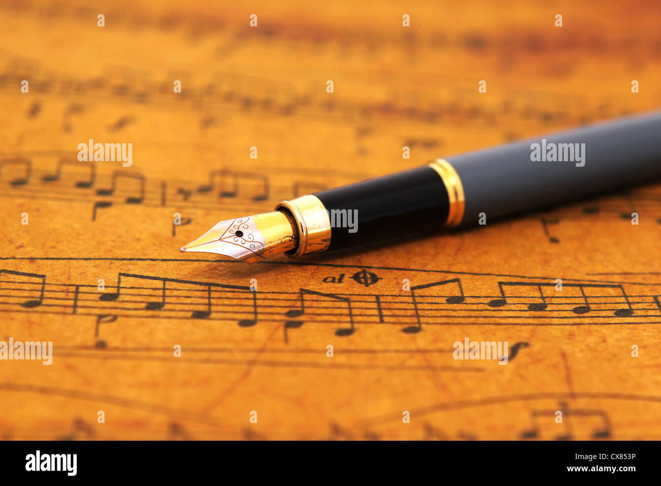 Pen on music sheet Stock Photo - Alamy