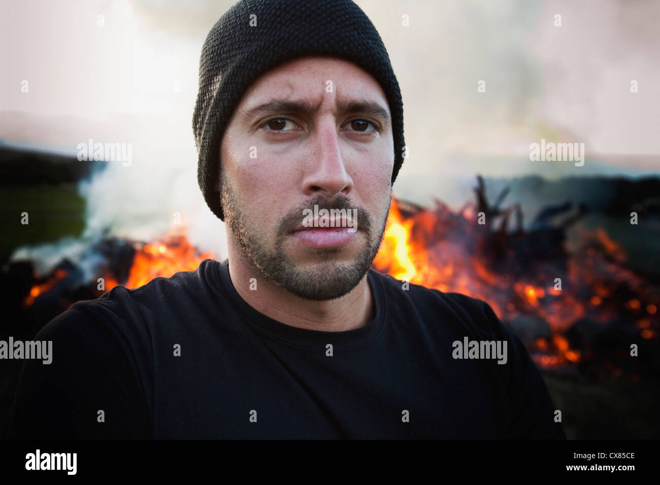 A Man Standing With A Fire Burning Behind Him; Dunsborough, West ...
