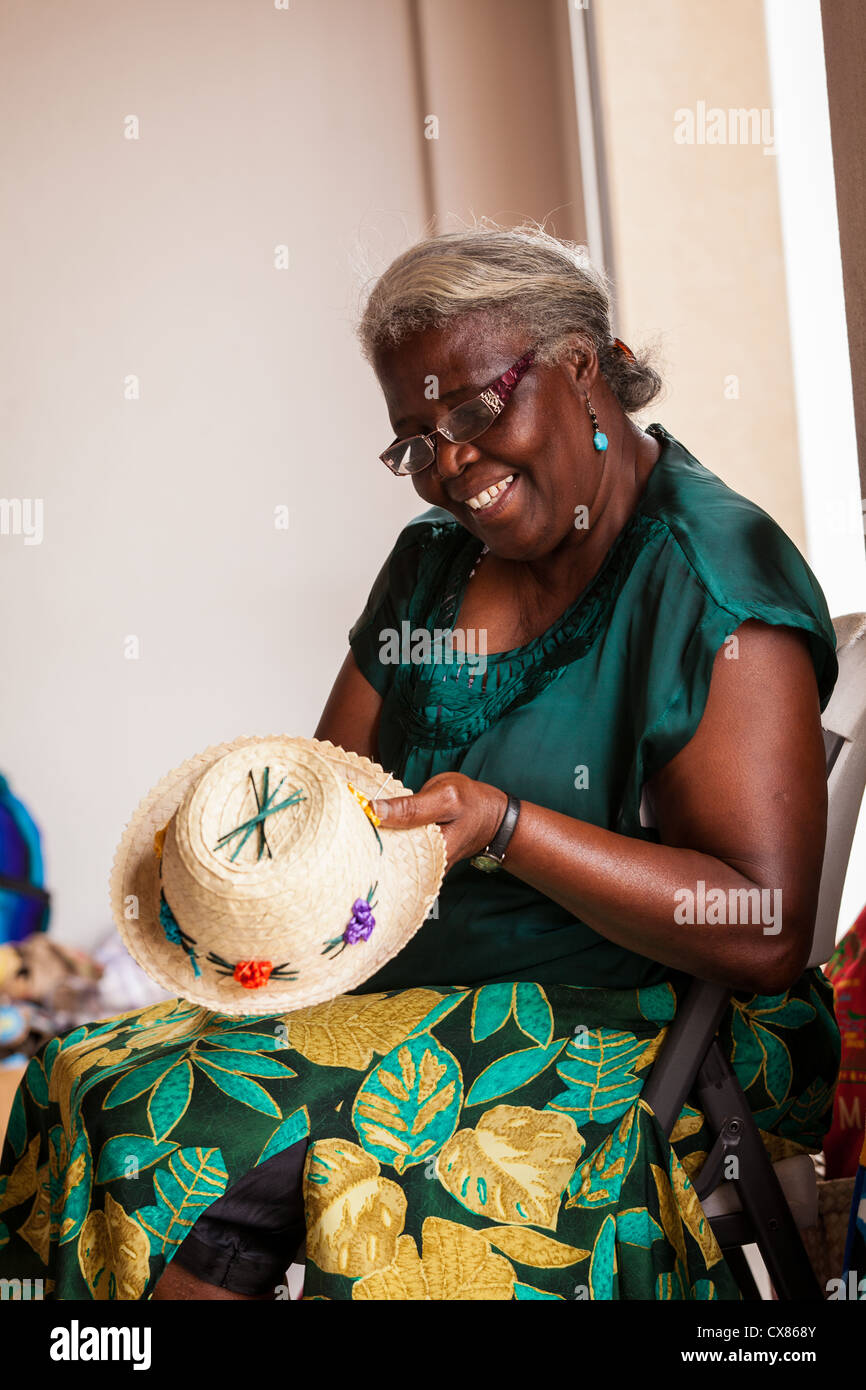 A basket maker weaves a straw hat at the Straw Market in Nassau ...