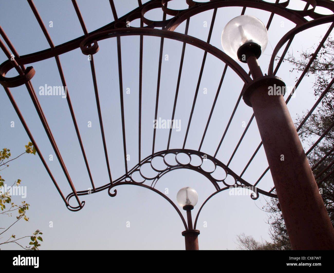 A metal structure, part of the lamp shade arrangement in a garden. This ...