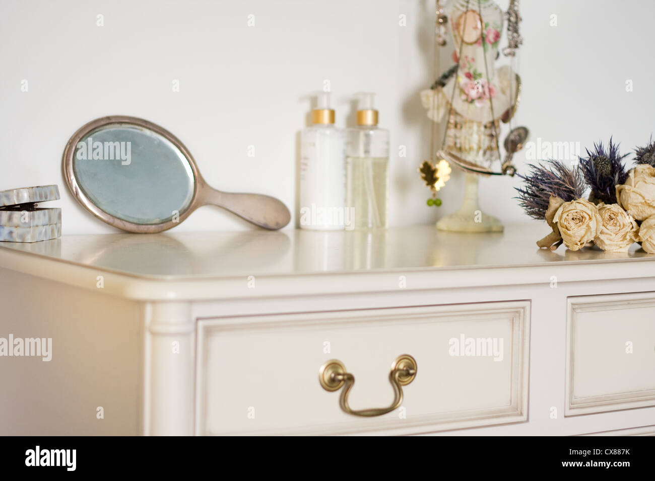 Modern dressing table, with hand mirror bottles, flowers. Landscape ...