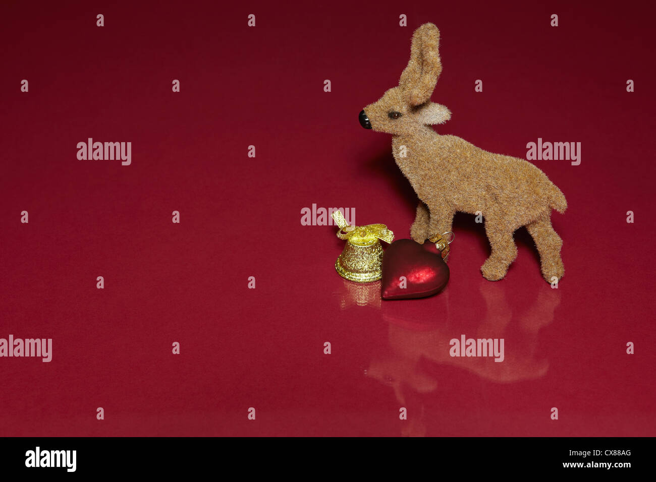 Reindeer, bell and heart with reflection Stock Photo - Alamy