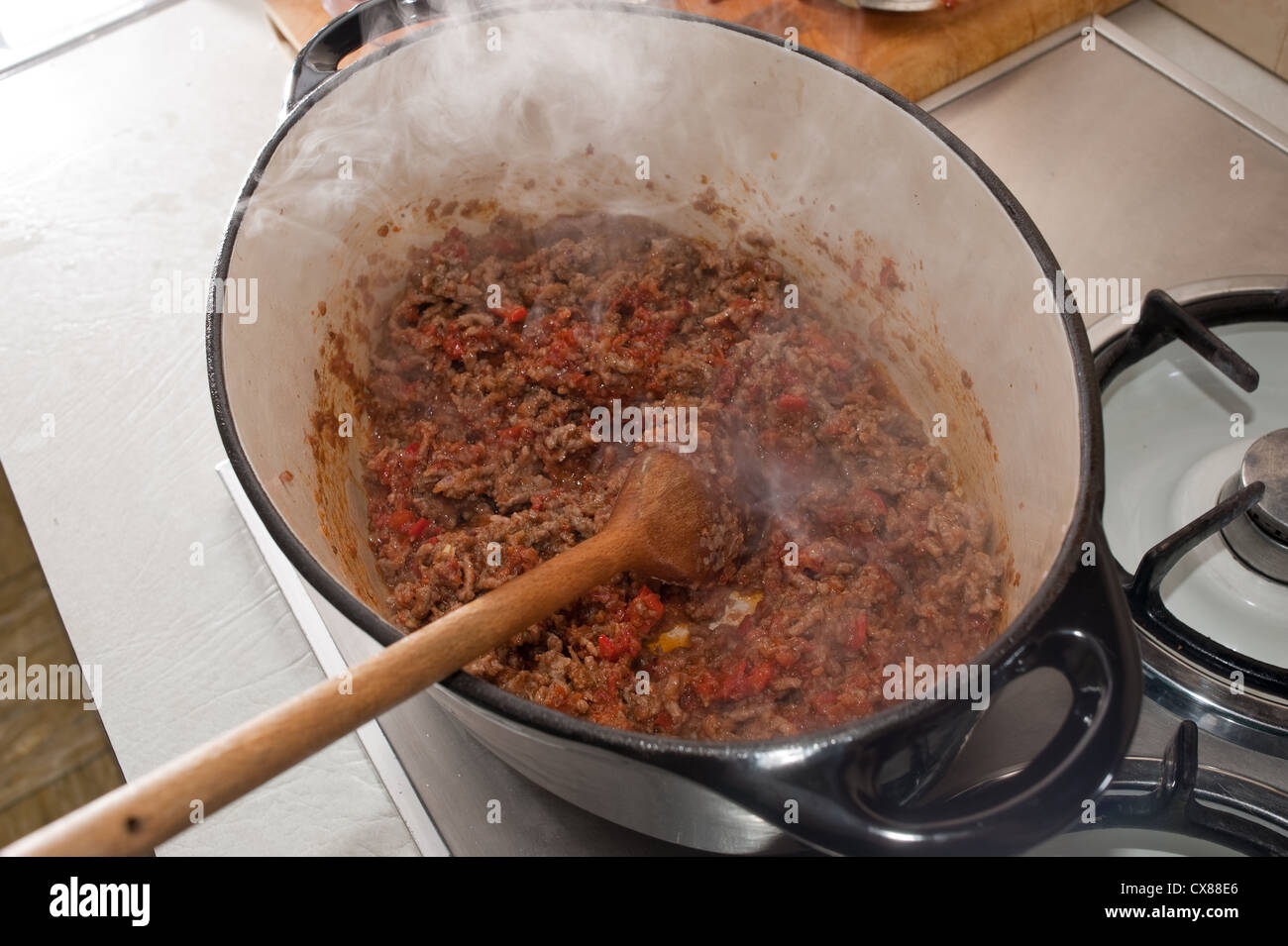 Preparing a chilli con carni meal on gas hob stove cooker 2012 UK Stock ...