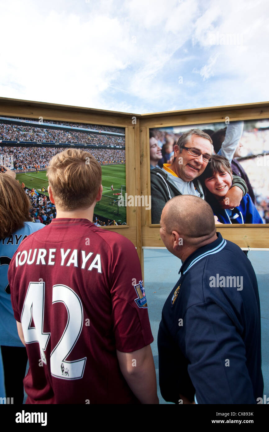 Fans look at the photo-boards outside the Etihad Stadium, Manchester ...