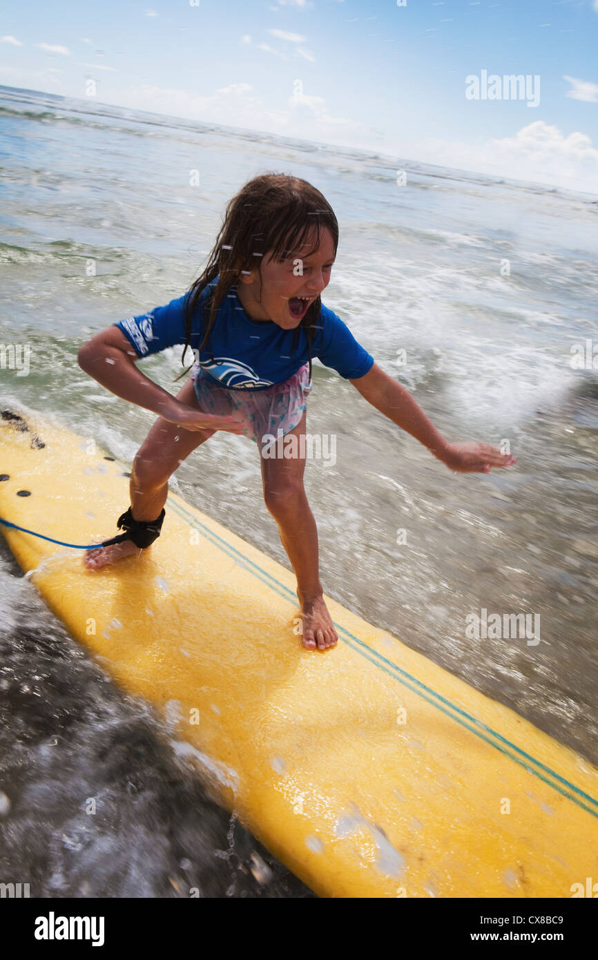 A Young Girl On A Yellow Surfboard; Gold Coast Queensland Australia ...