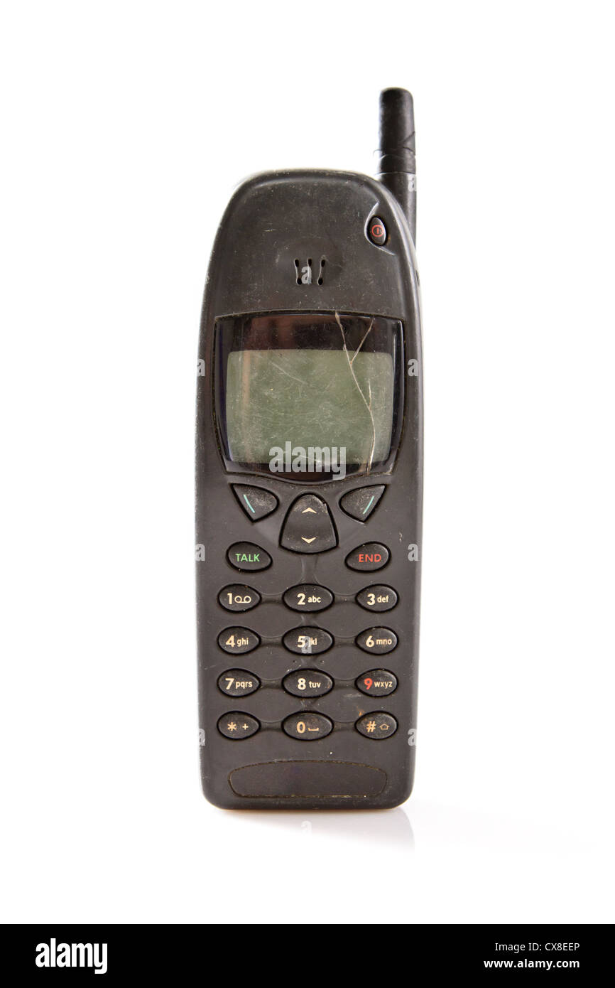 Old black cell phone isolated on the white background broken screen ...