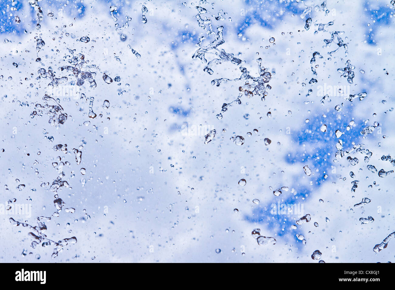 Raindrops of a waterfall falling with blue sky Stock Photo - Alamy