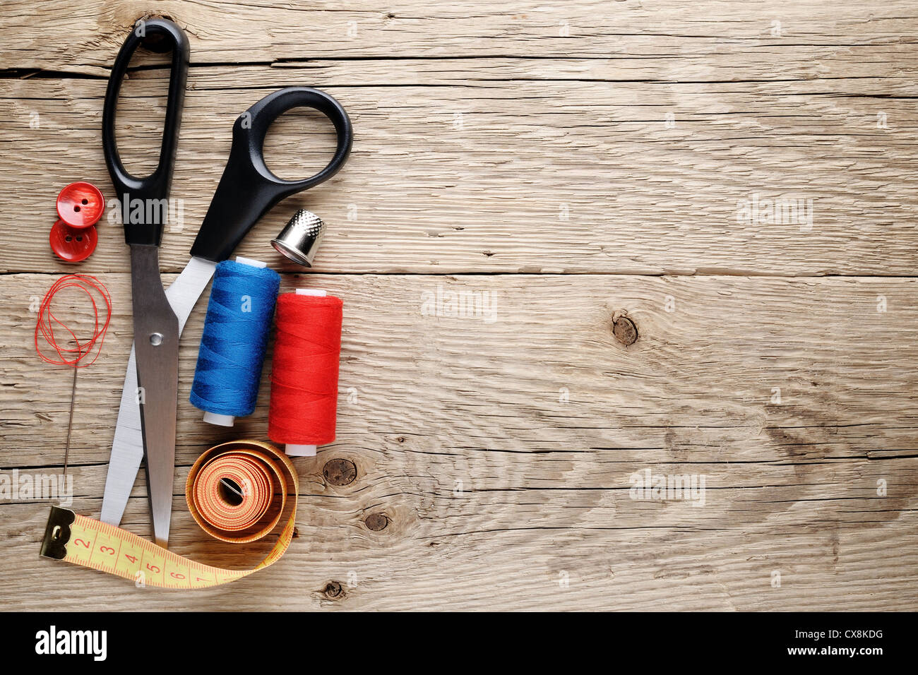 Sewing accessories on wooden background Stock Photo - Alamy