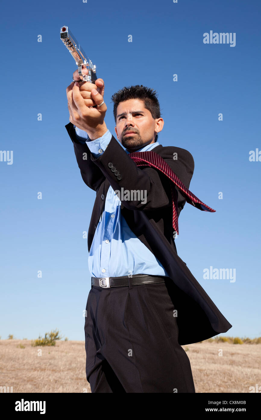 Powerful businessman with a gun in outdoor Stock Photo - Alamy