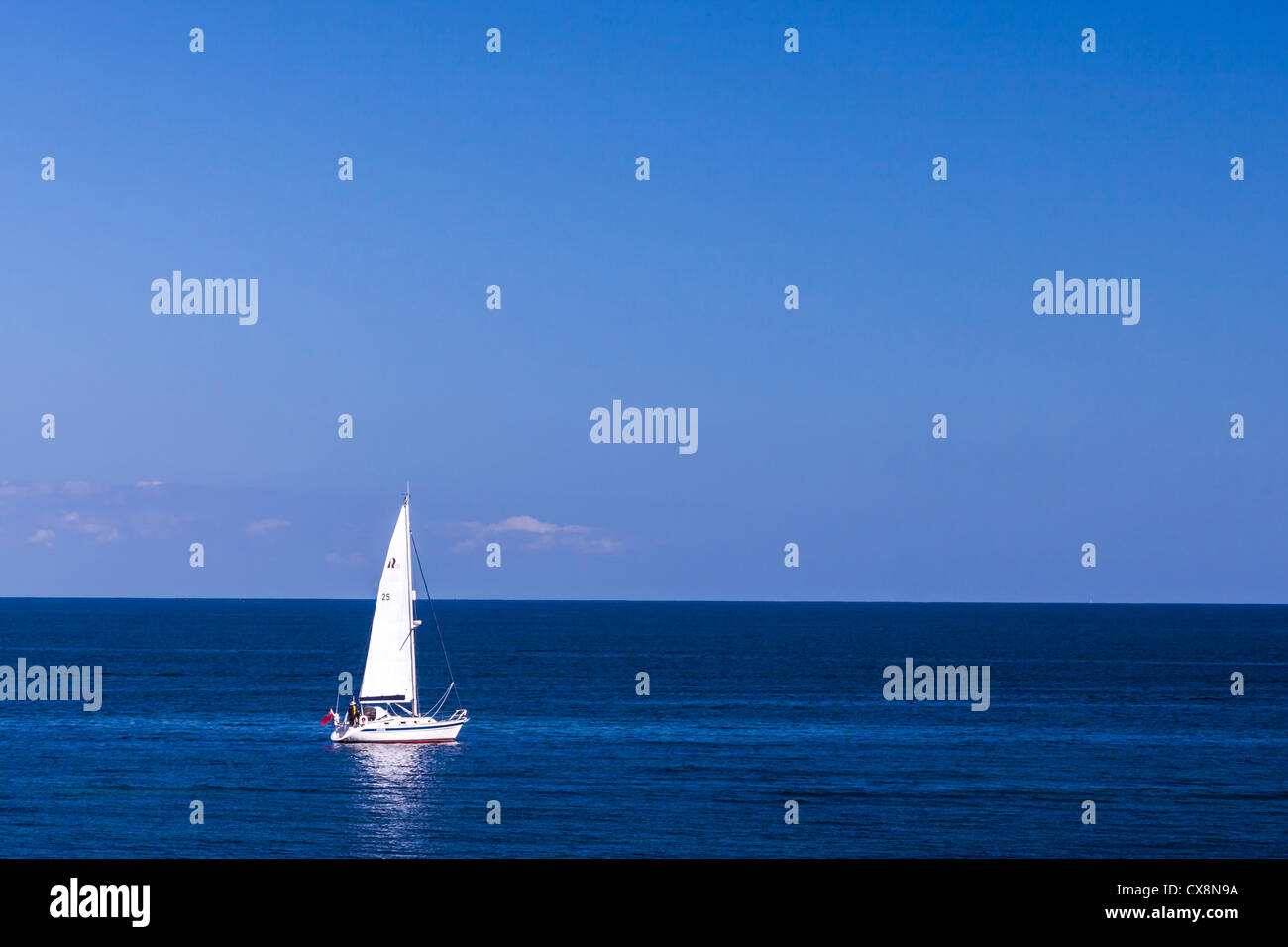 Small sailing yacht in the big blue sea Stock Photo - Alamy