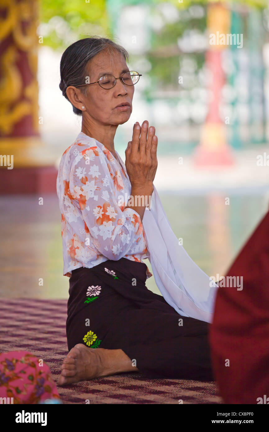 Woman at prayer at the KUTHODAW PAYA which houses 729 marble slabs of ...
