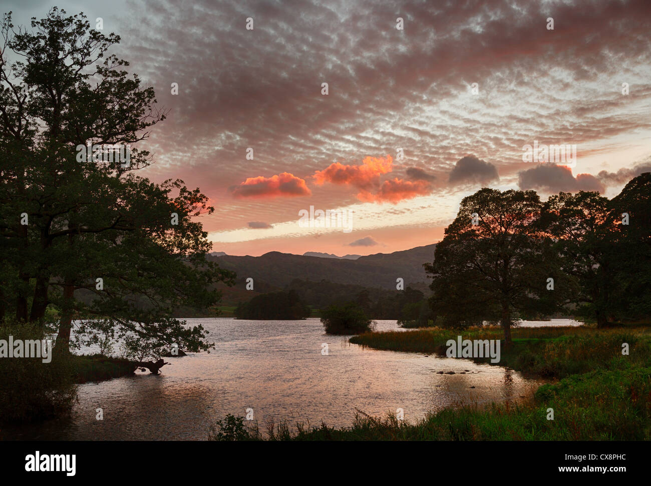 Setting sun illuminates clouds over Rydal Water in English Lake ...