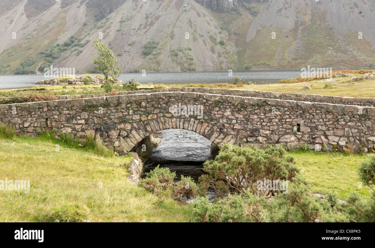 Ancient stone bridge over river running into Wastwater in Lake District ...