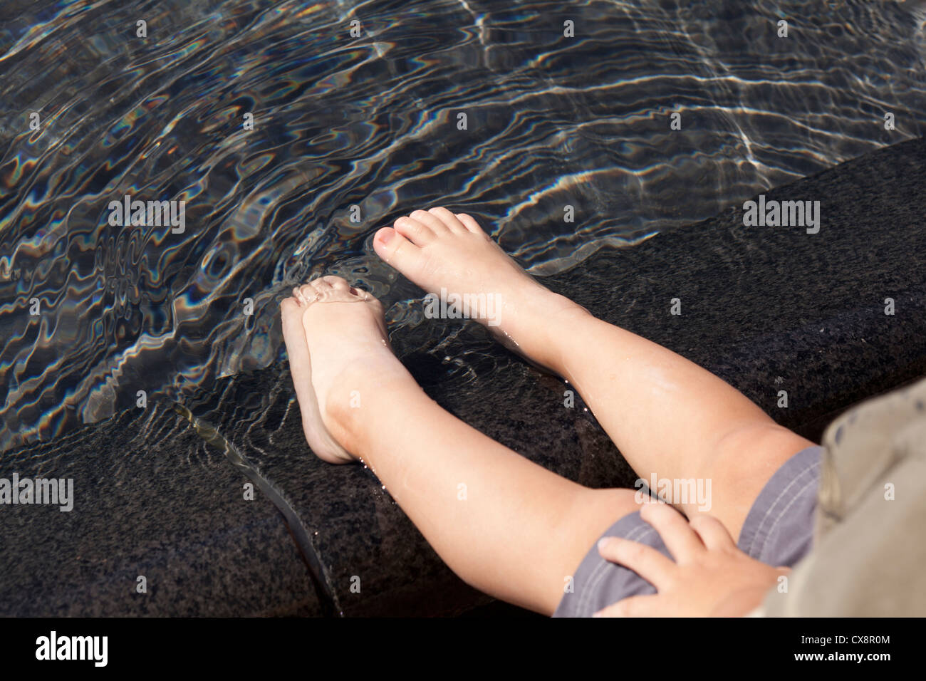 A child dipping his feet in water Stock Photo - Alamy