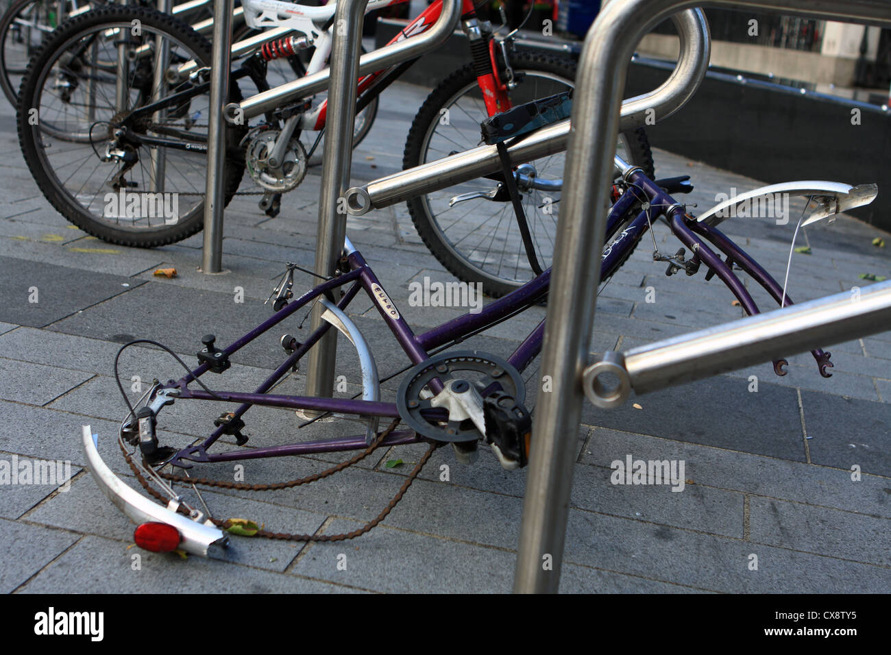 a vandalised cycle still chained to a cycle rack in London - other ...