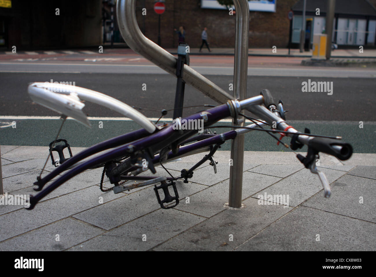 Bicycle locked to a cycle rack on a street hi-res stock photography and ...