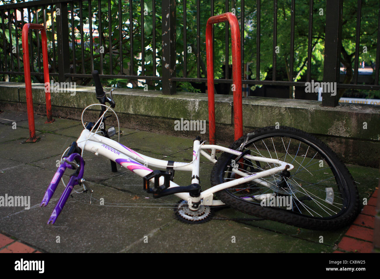 Bicycle locked to a cycle rack on a street hi-res stock photography and ...