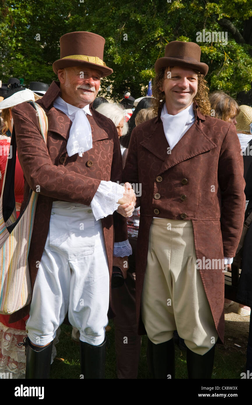 Men in Regency costume promenade through Bath city centre during the ...