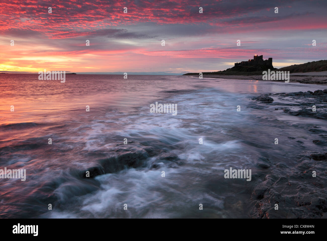 Sunrise over Bamburgh Castle on the Northumberland coast Stock Photo ...